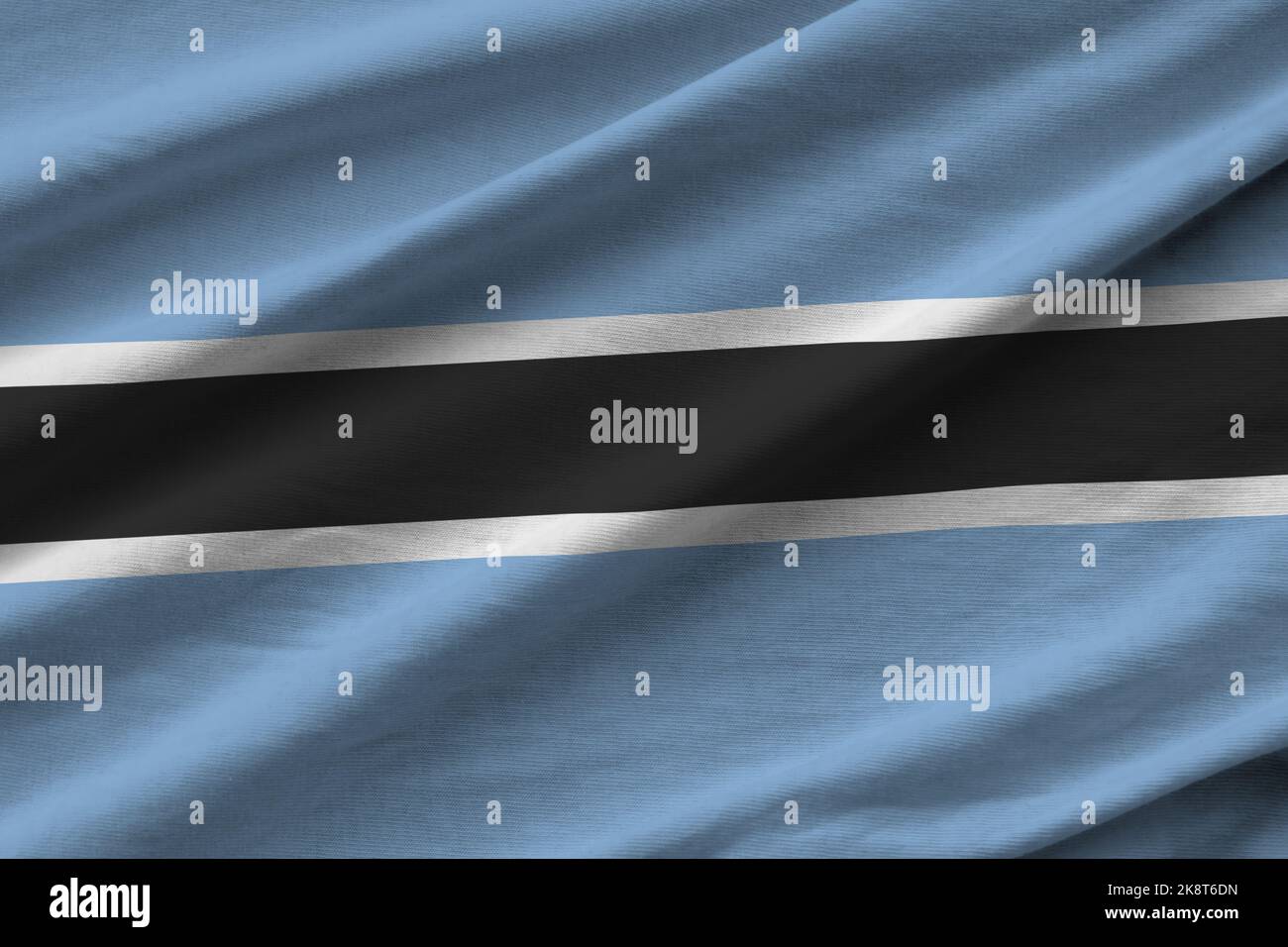 Botswana flag with big folds waving close up under the studio light ...