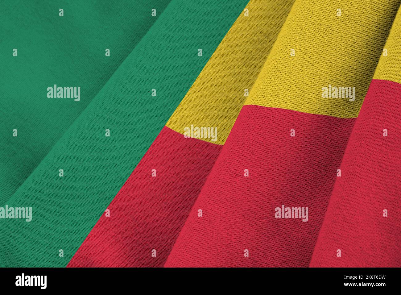 Benin flag with big folds waving close up under the studio light ...