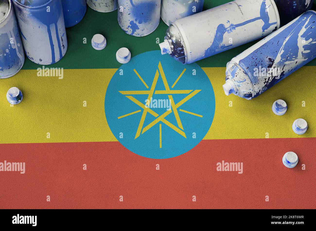 Ethiopia flag and few used aerosol spray cans for graffiti painting ...