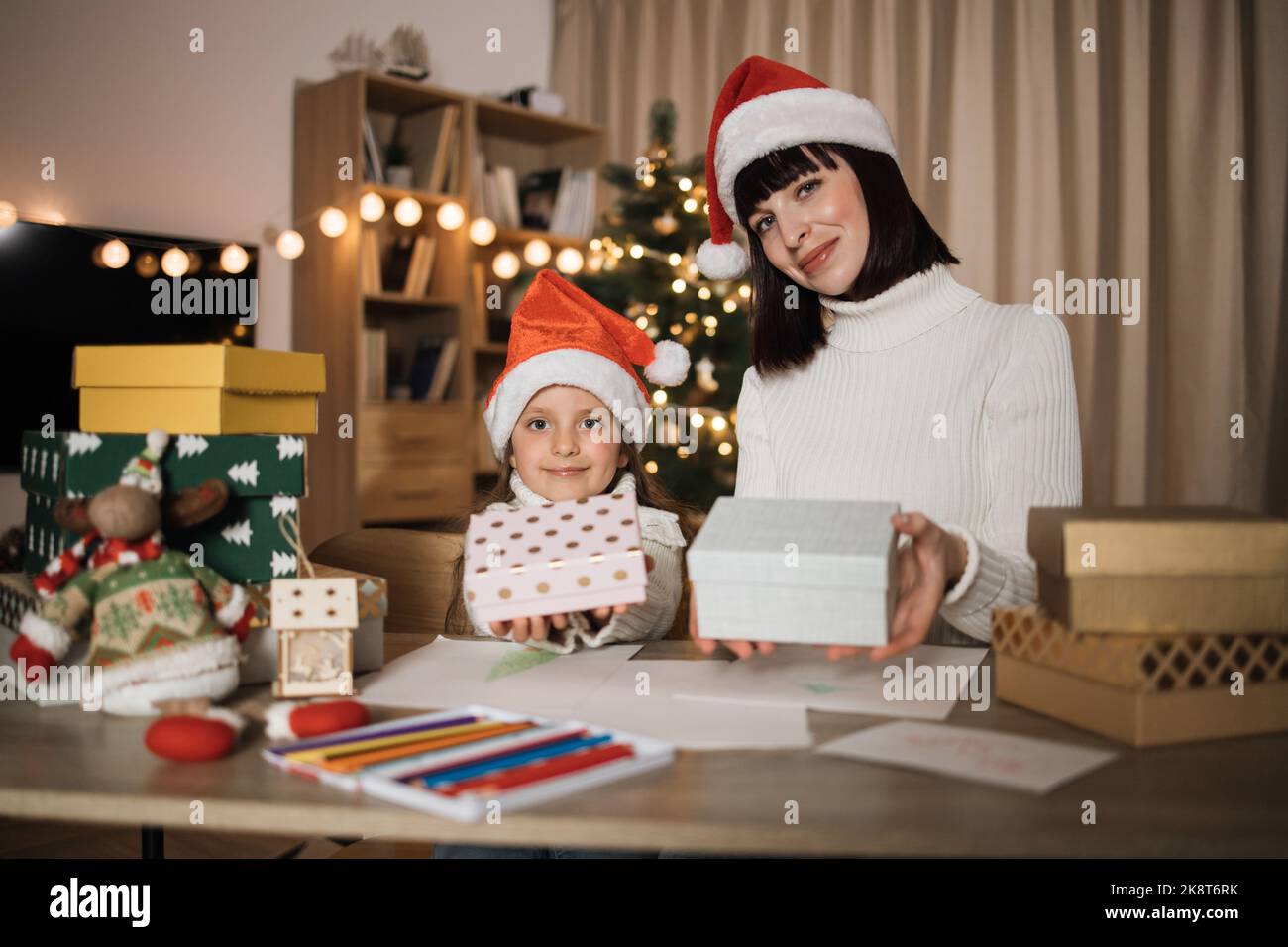 Merry Christmas and Happy Holidays. Young happy mother and little cute ...