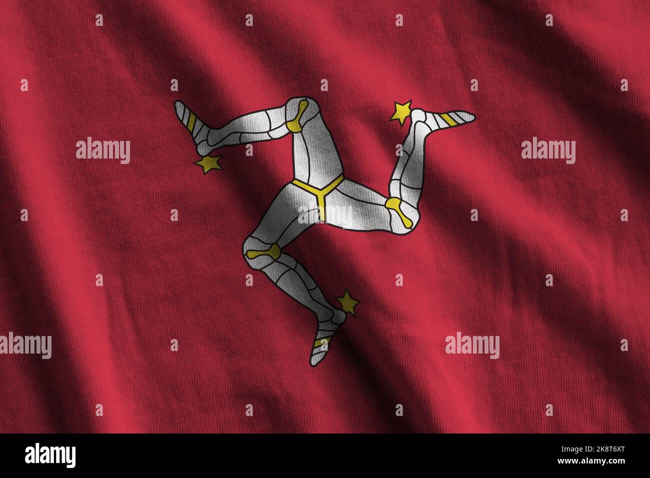 Isle of Man flag with big folds waving close up under the studio light ...