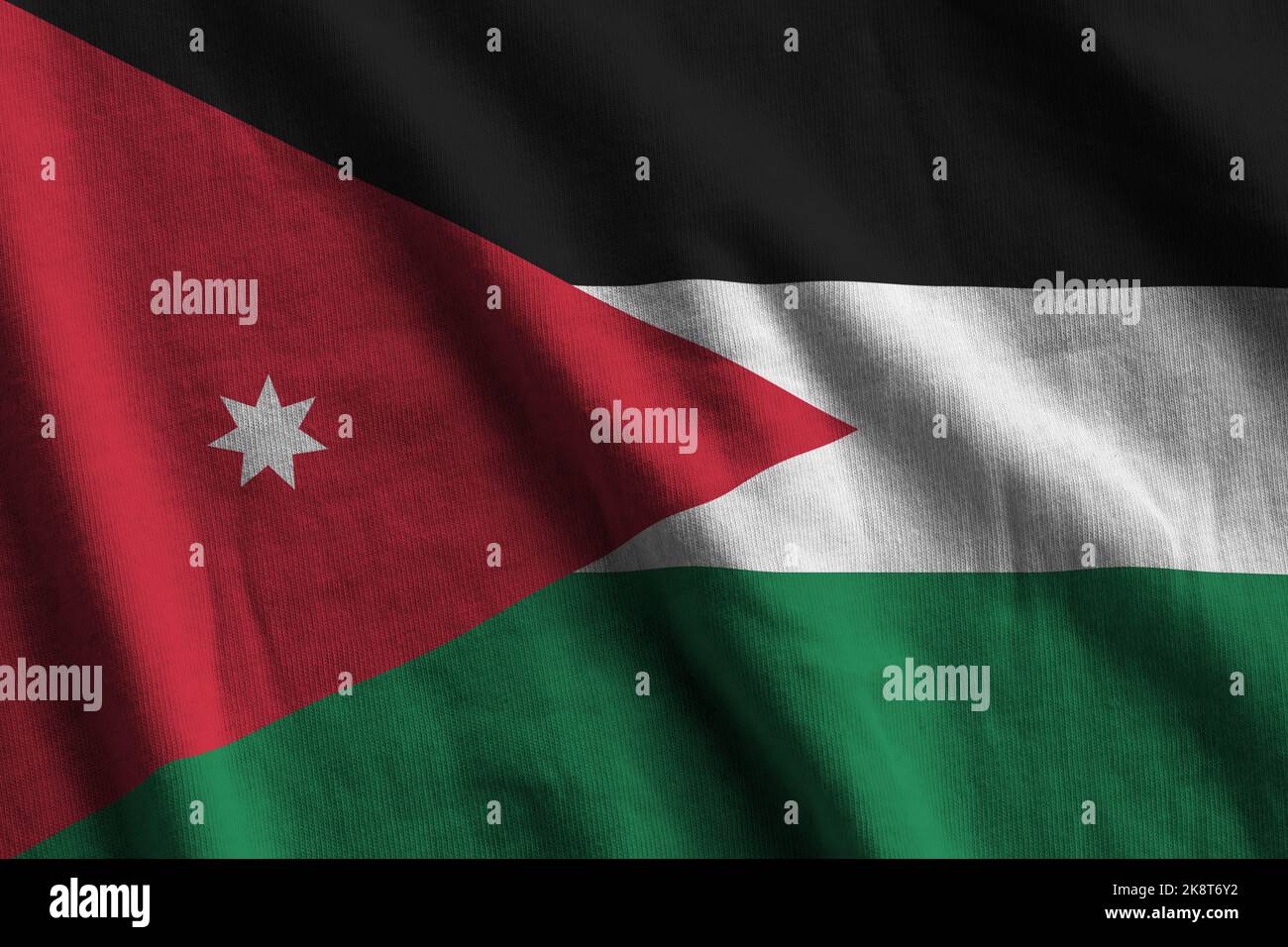 Jordan flag with big folds waving close up under the studio light ...