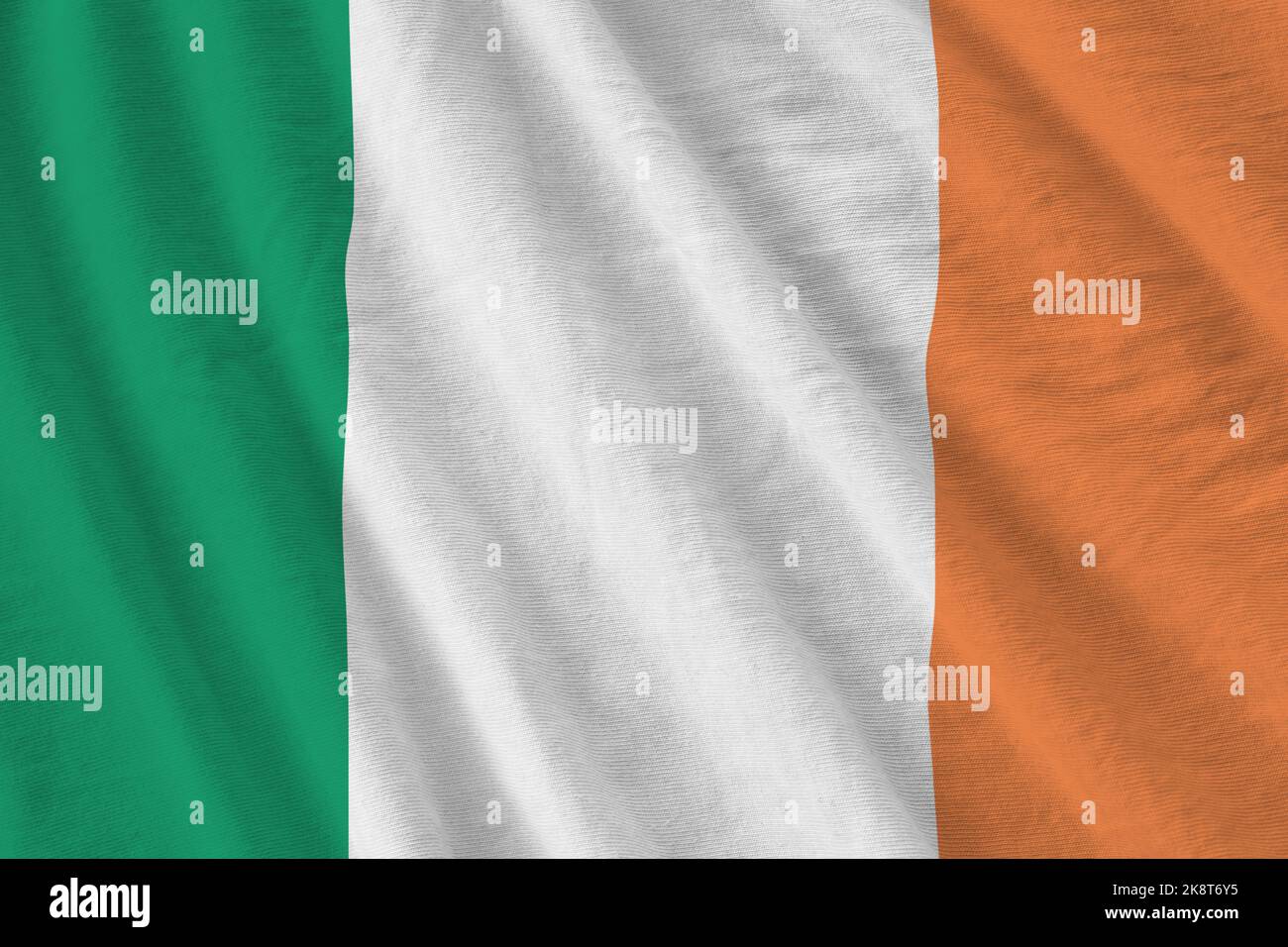 Ireland flag with big folds waving close up under the studio light ...