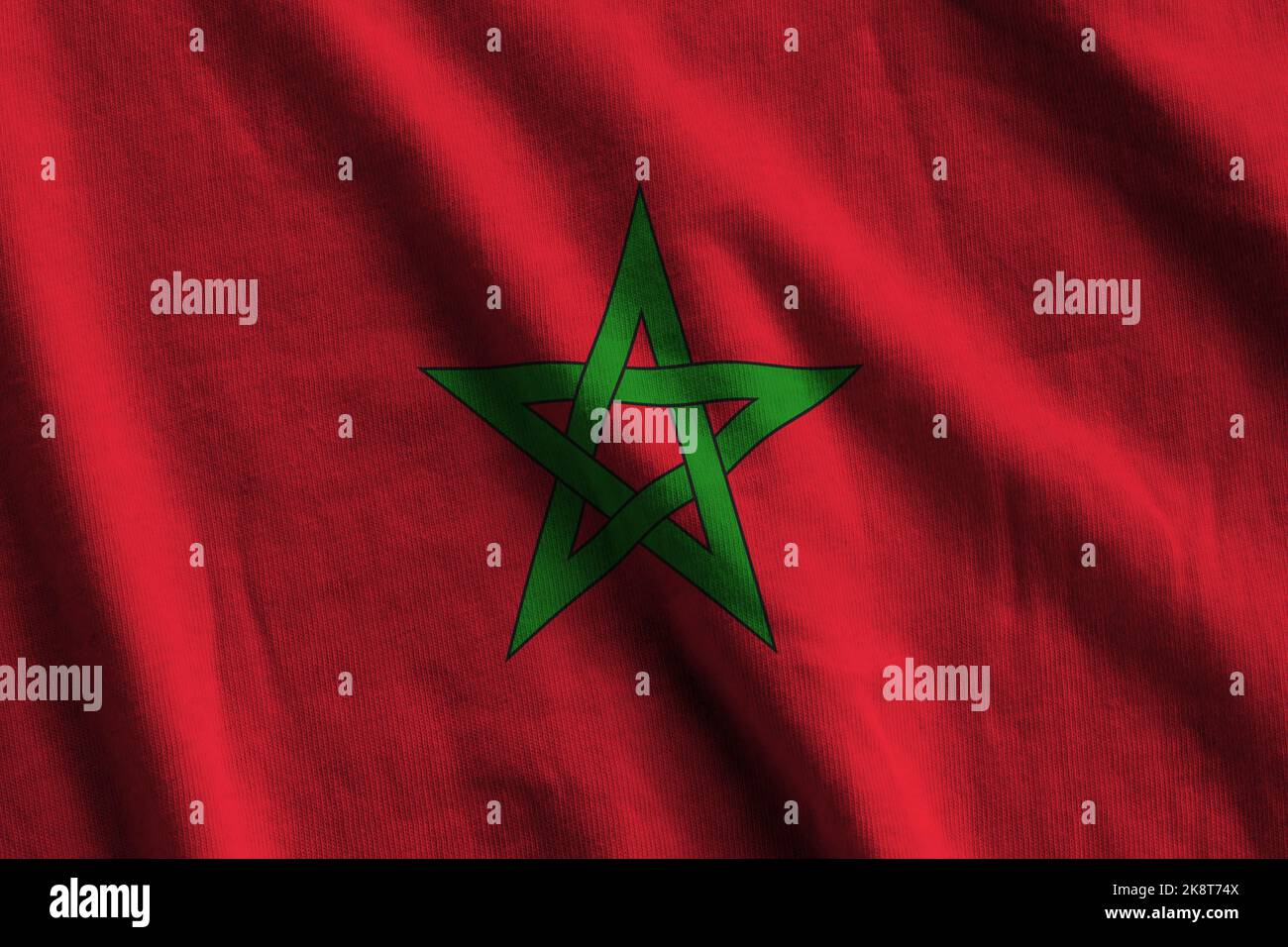 Morocco flag with big folds waving close up under the studio light ...
