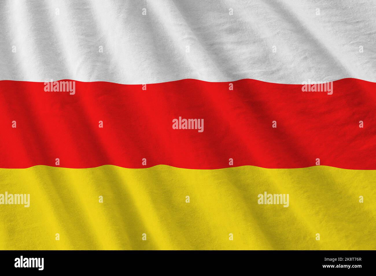 South Ossetia flag with big folds waving close up under the studio ...
