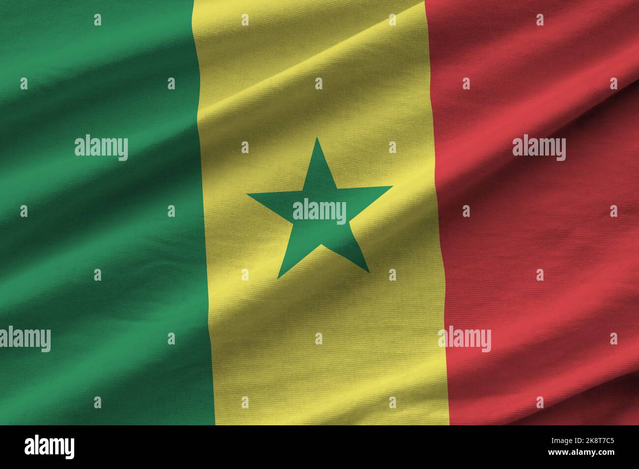 Senegal flag with big folds waving close up under the studio light ...