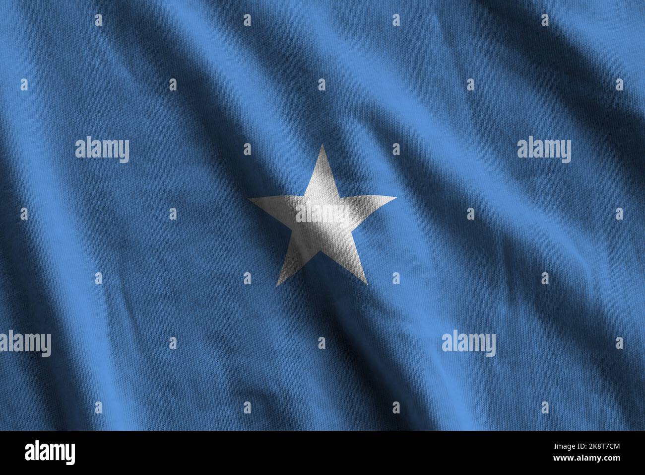 Somalia flag with big folds waving close up under the studio light ...