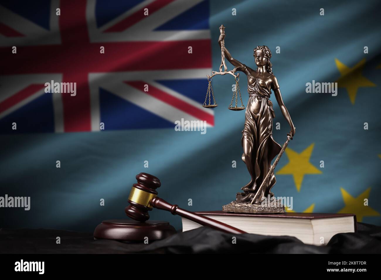 Tuvalu flag with statue of lady justice, constitution and judge hammer ...