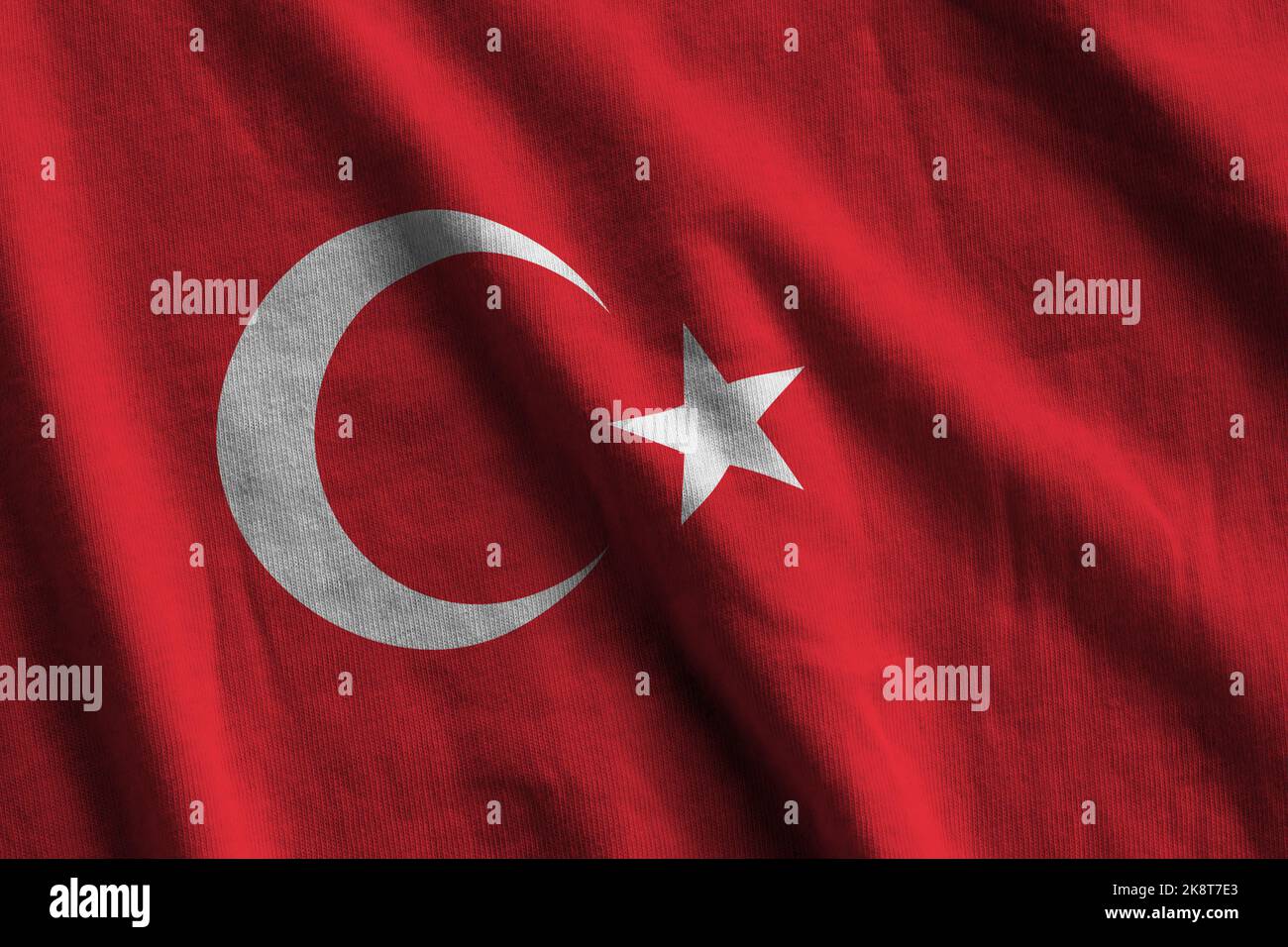 Turkey flag with big folds waving close up under the studio light ...