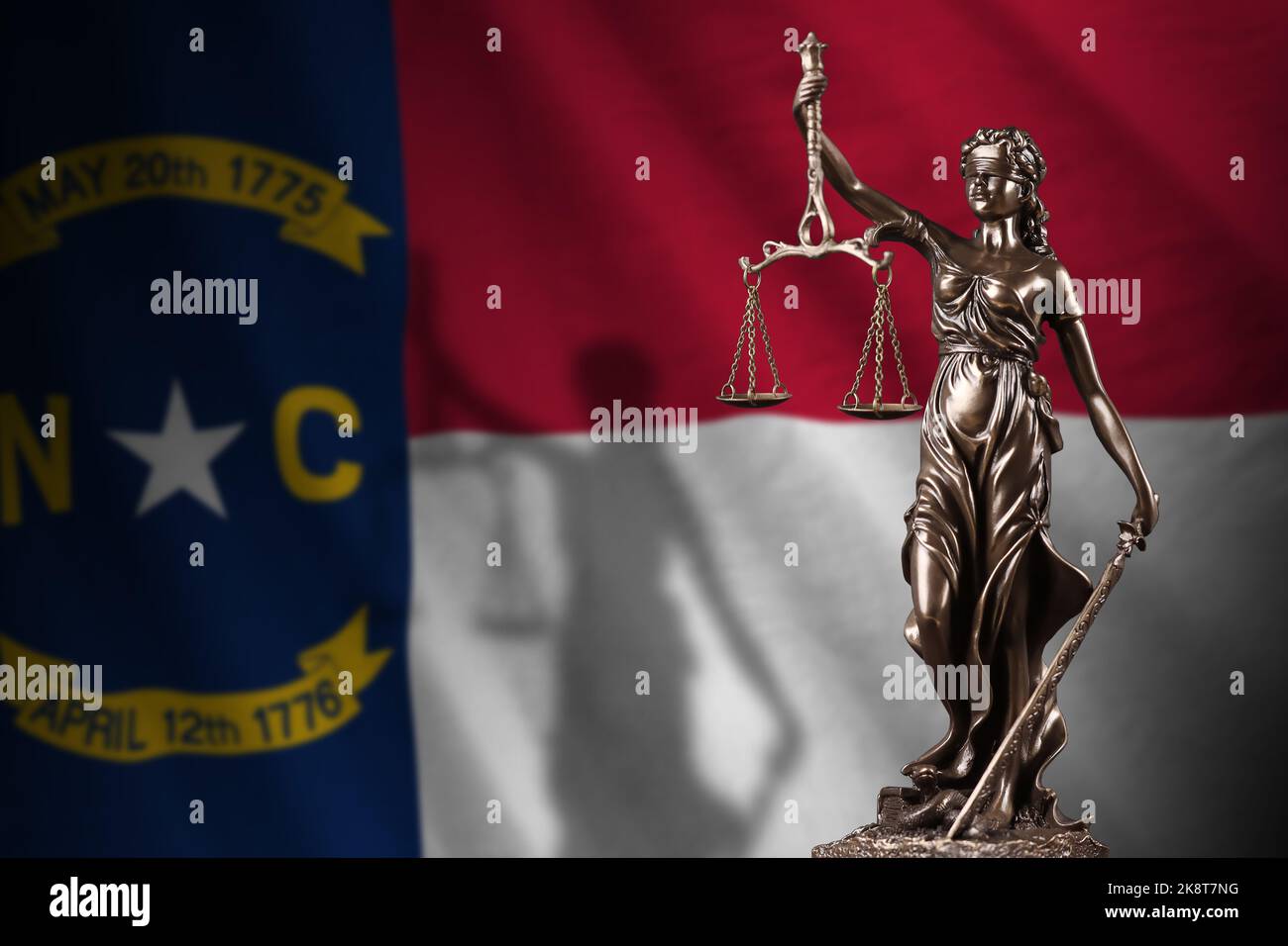 North Carolina US state flag with statue of lady justice and judicial ...