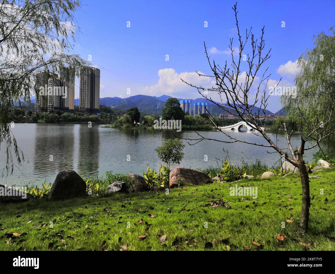 A scenic view of the architecture behind the beautiful lake on a sunny ...