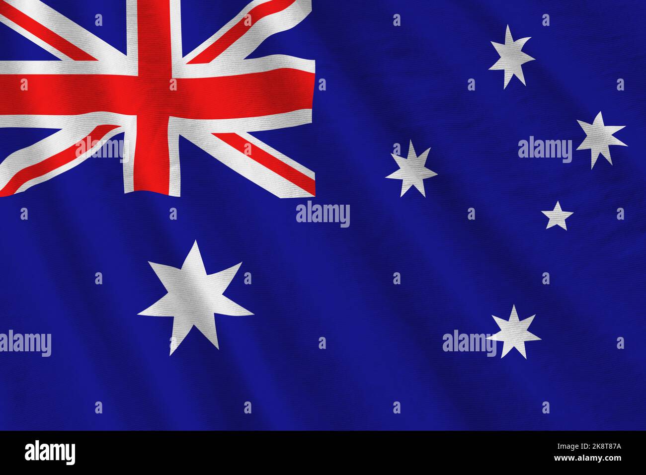 Australia flag with big folds waving close up under the studio light ...