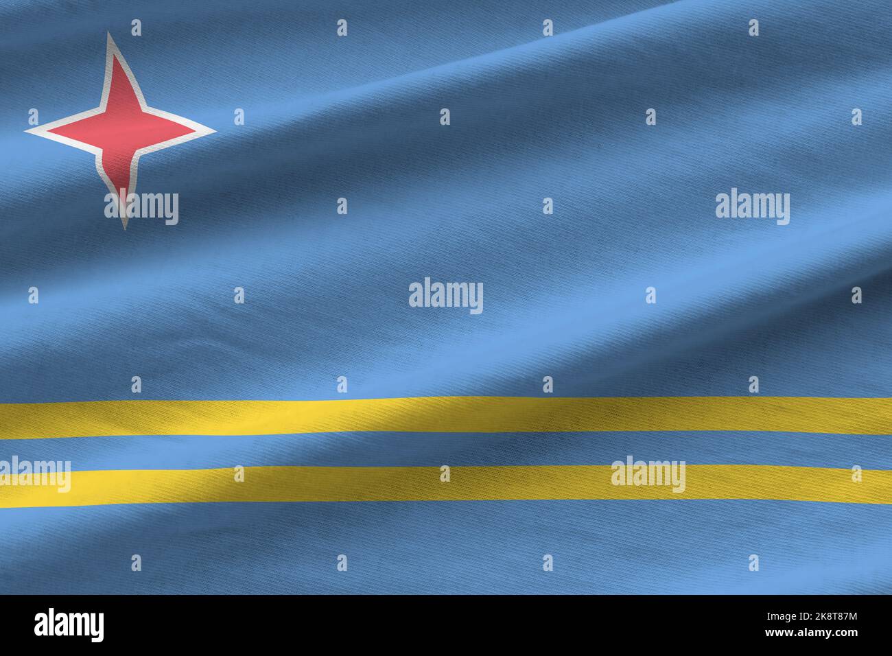 Aruba flag with big folds waving close up under the studio light ...