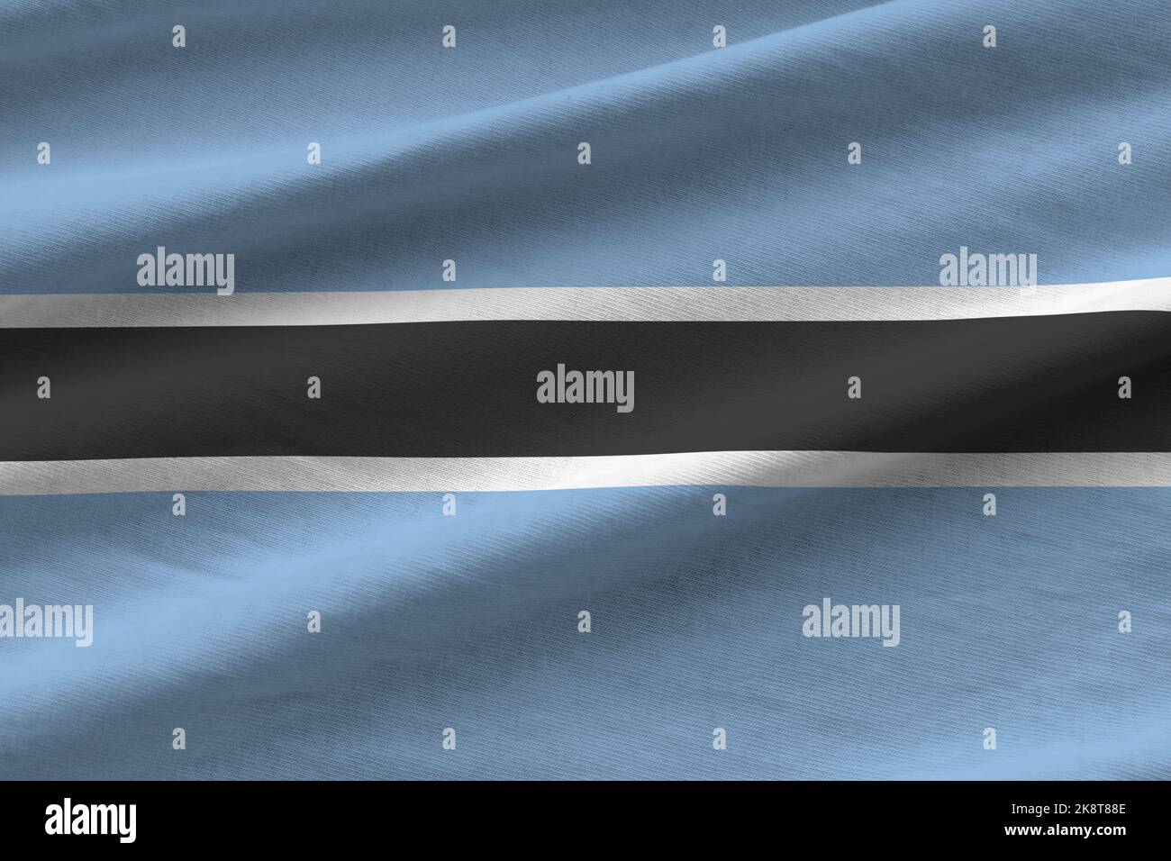 Botswana flag with big folds waving close up under the studio light ...