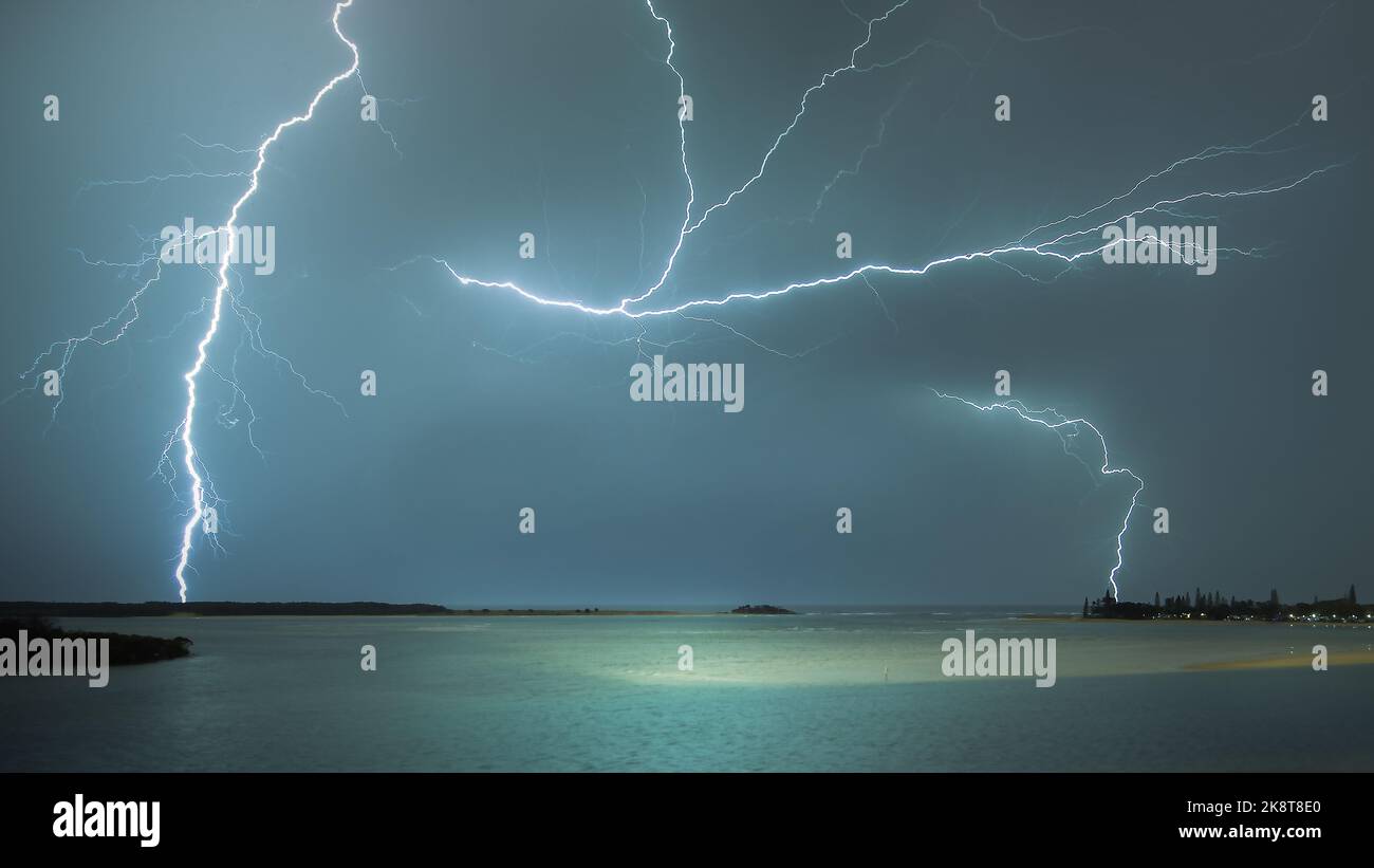 A magical view of a striking lightning over a sea location in a stormy ...