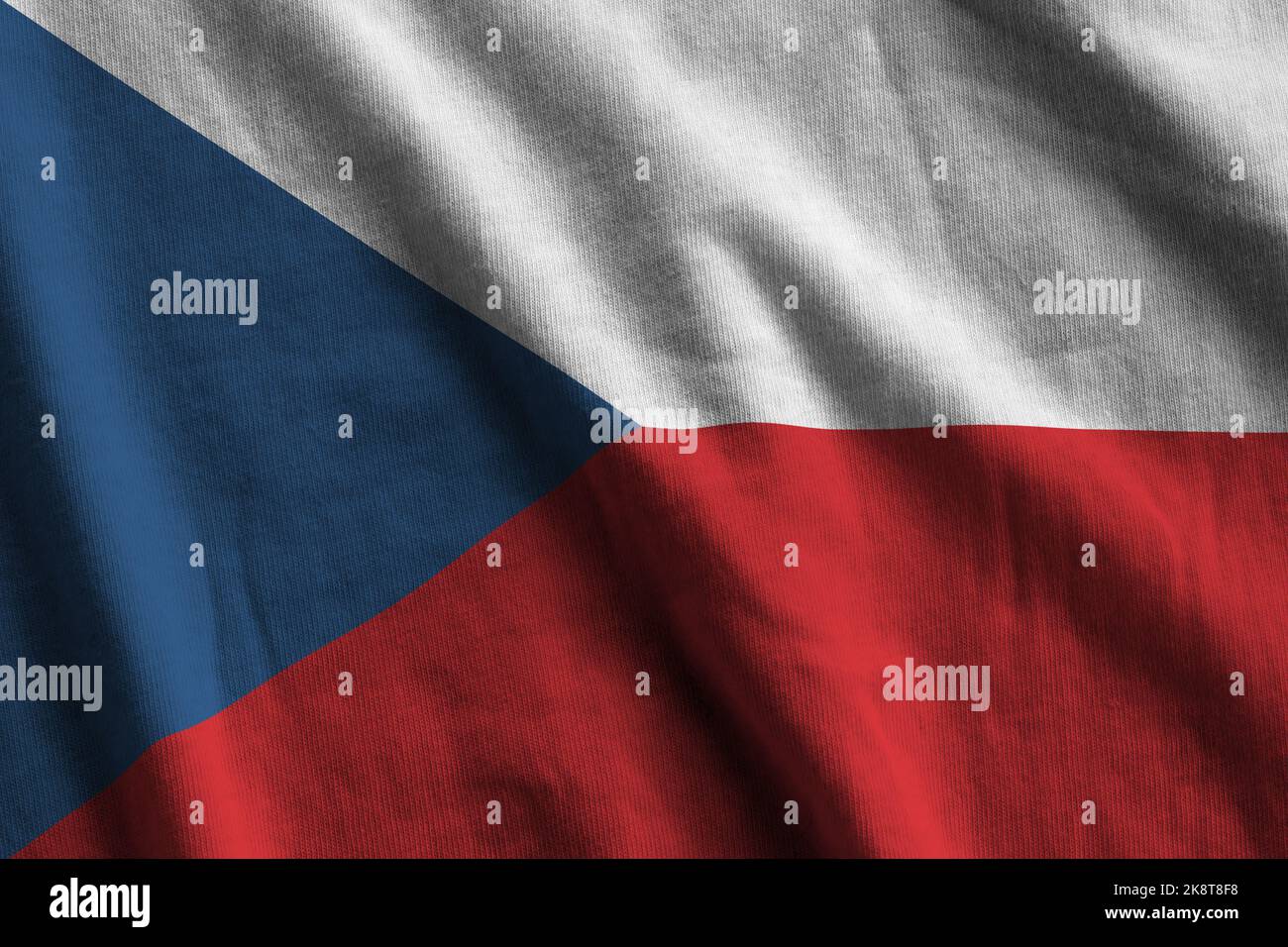 Czech flag with big folds waving close up under the studio light ...