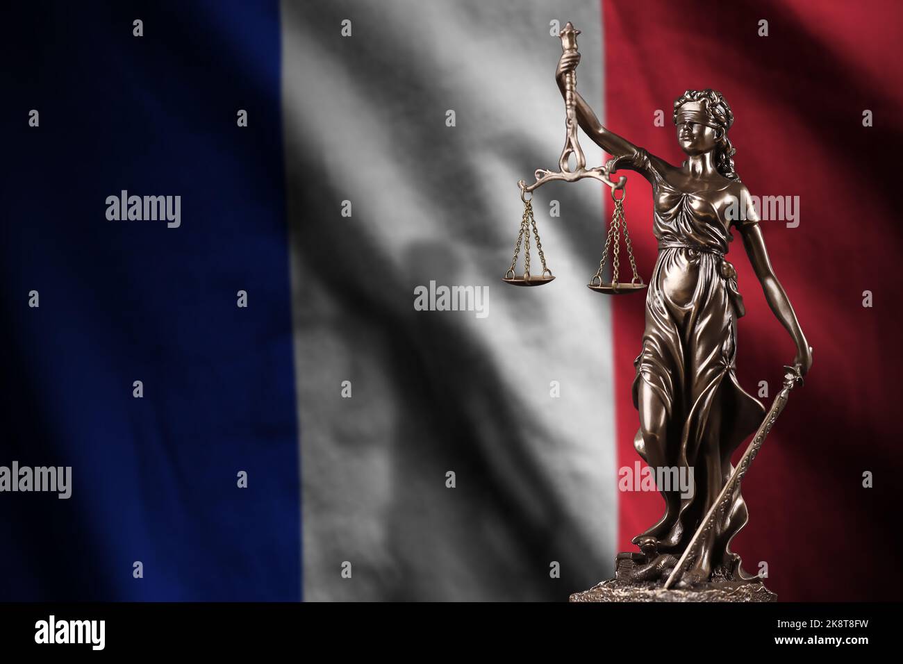 France flag with statue of lady justice and judicial scales in dark ...