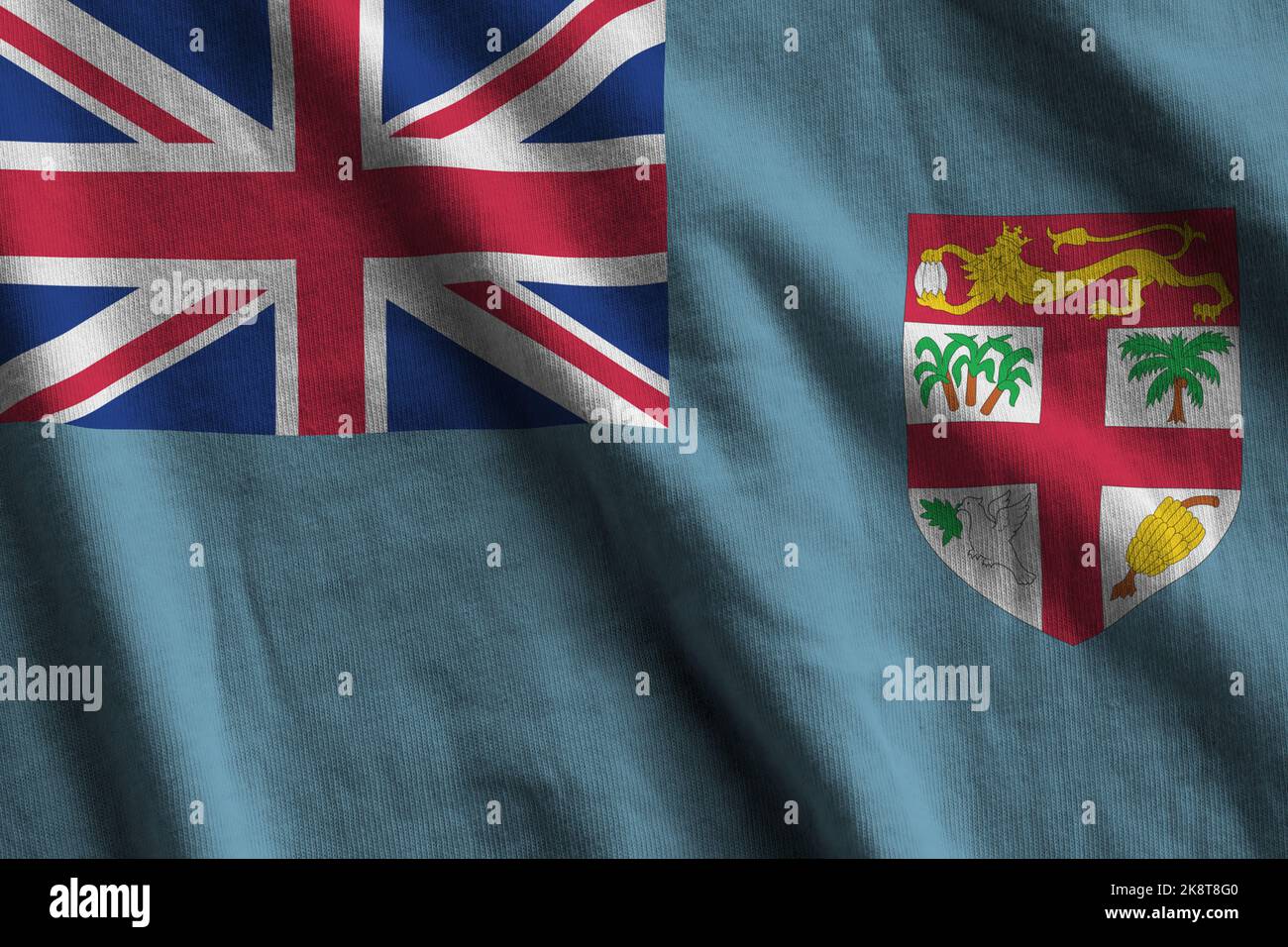 Fiji flag with big folds waving close up under the studio light indoors ...