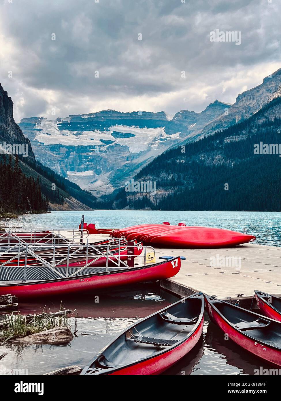 A vertical closeup of Banff National Park with boats near, snowy ...