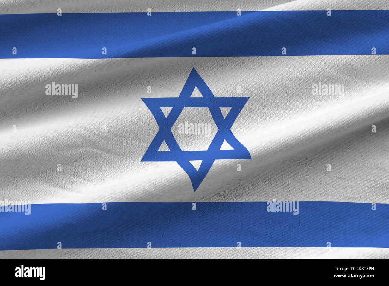 Israel flag with big folds waving close up under the studio light ...