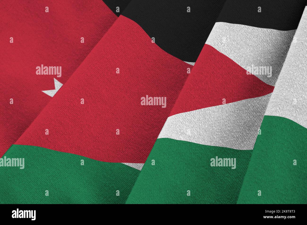 Jordan flag with big folds waving close up under the studio light ...