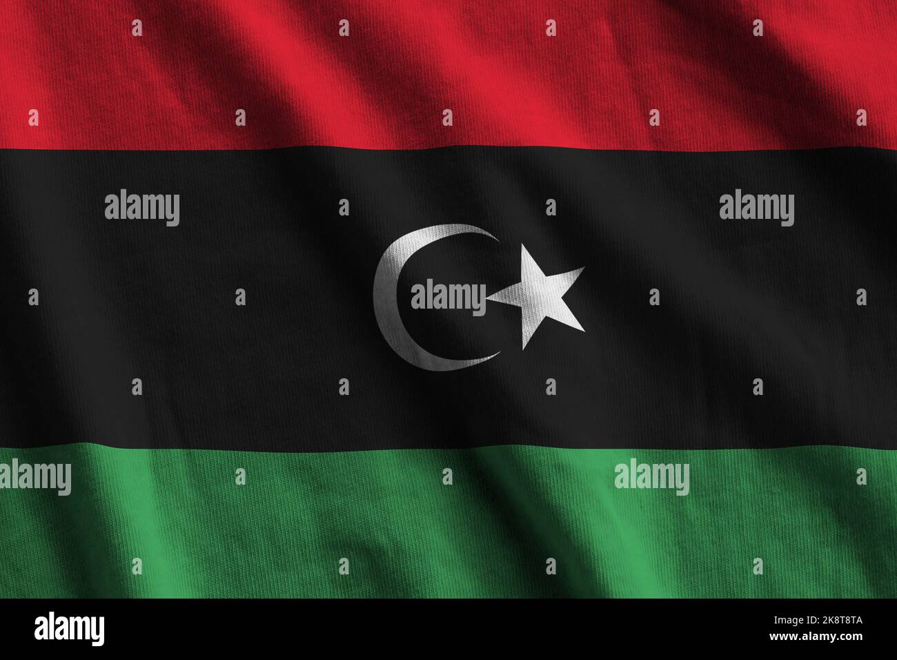 Libya flag with big folds waving close up under the studio light ...