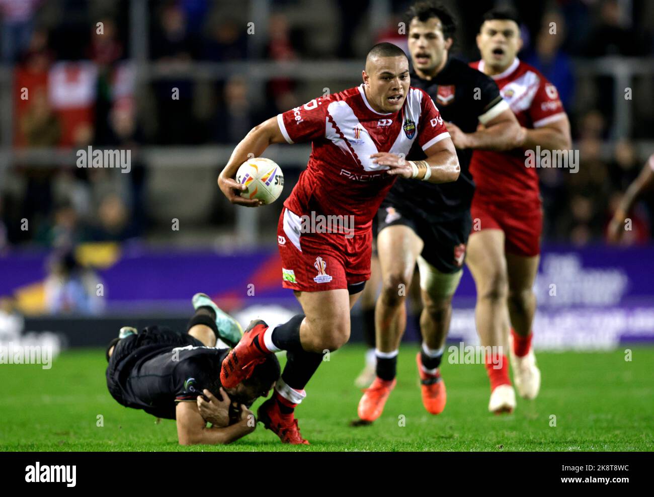 Tonga's Tui Lolohea attempts to break away from a Wales tackle during ...