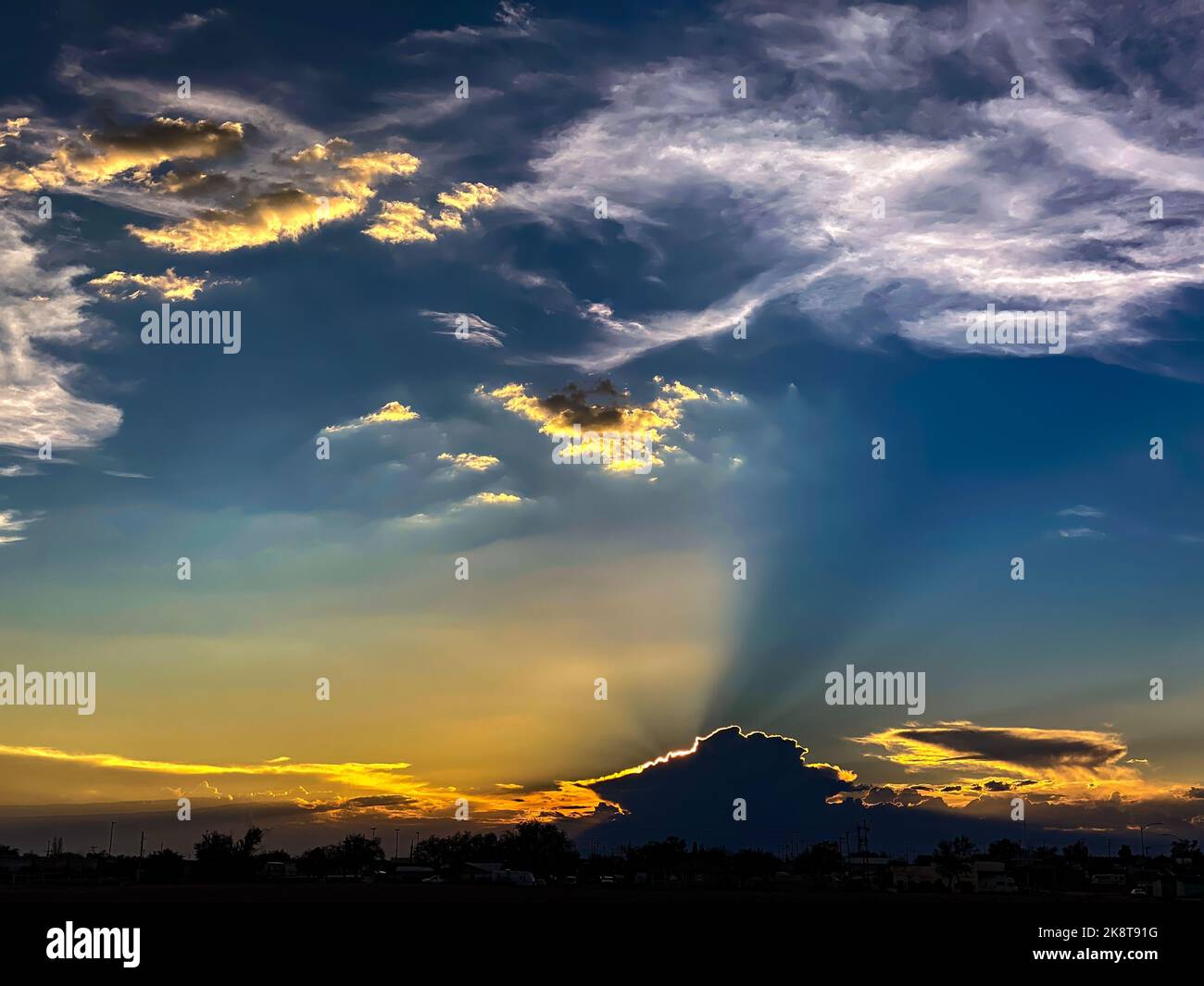 Beautiful sunset cloudscape with bright white and yellow clouds in blue ...