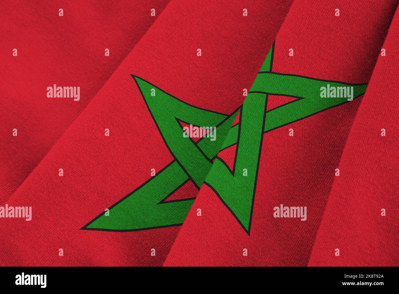 Morocco flag with big folds waving close up under the studio light ...