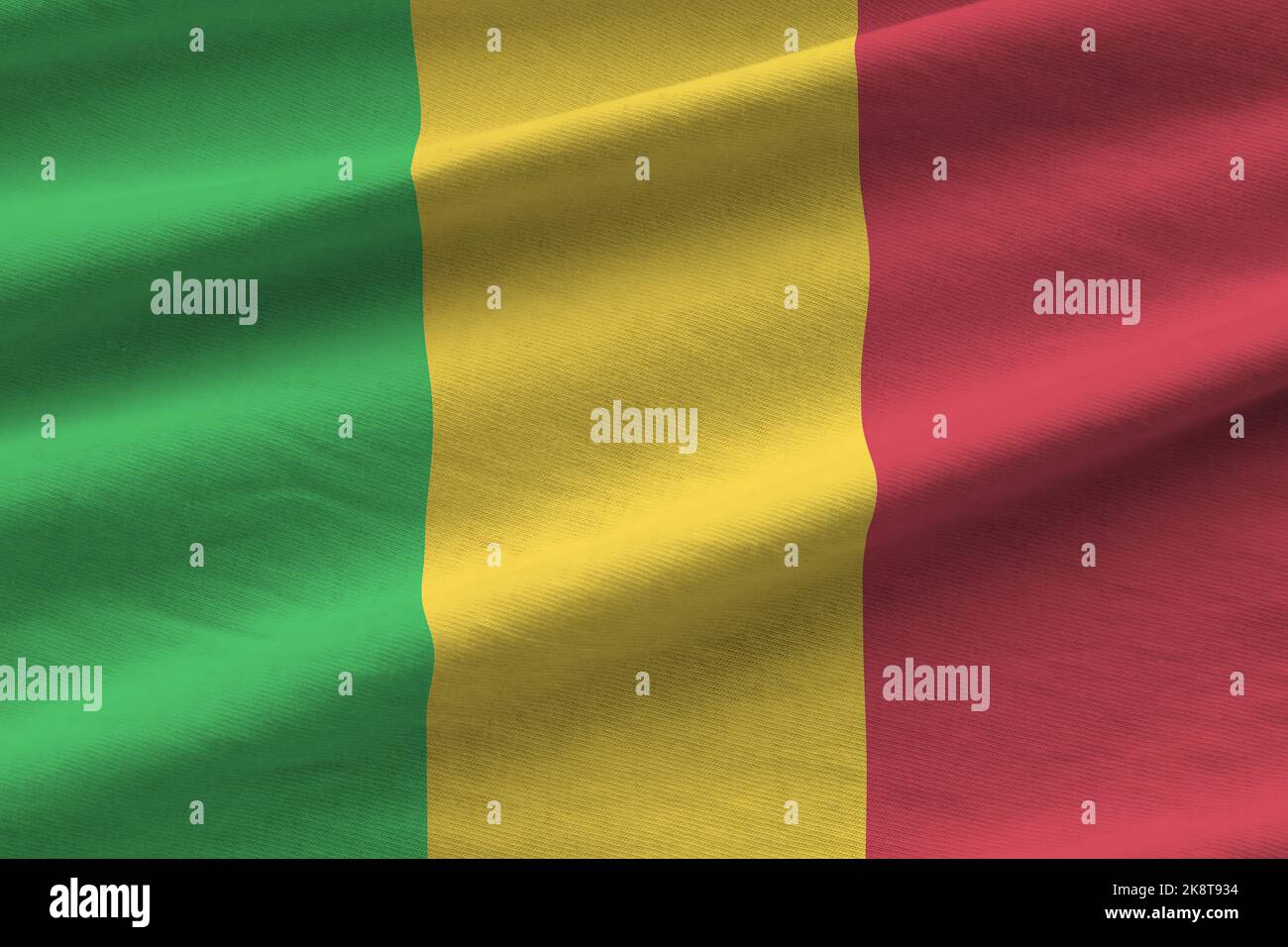 Mali flag with big folds waving close up under the studio light indoors ...