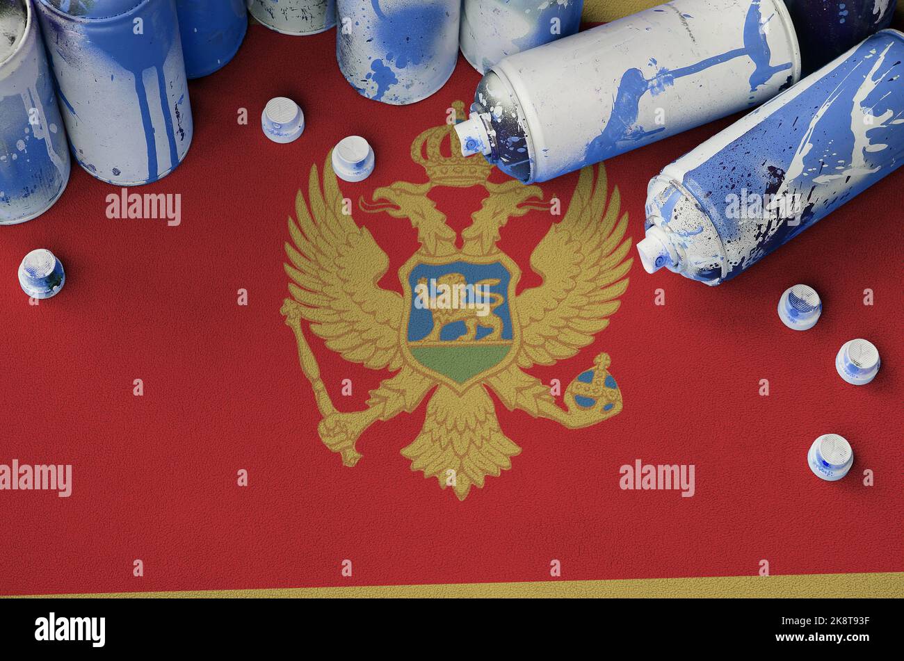 Montenegro flag and few used aerosol spray cans for graffiti painting ...
