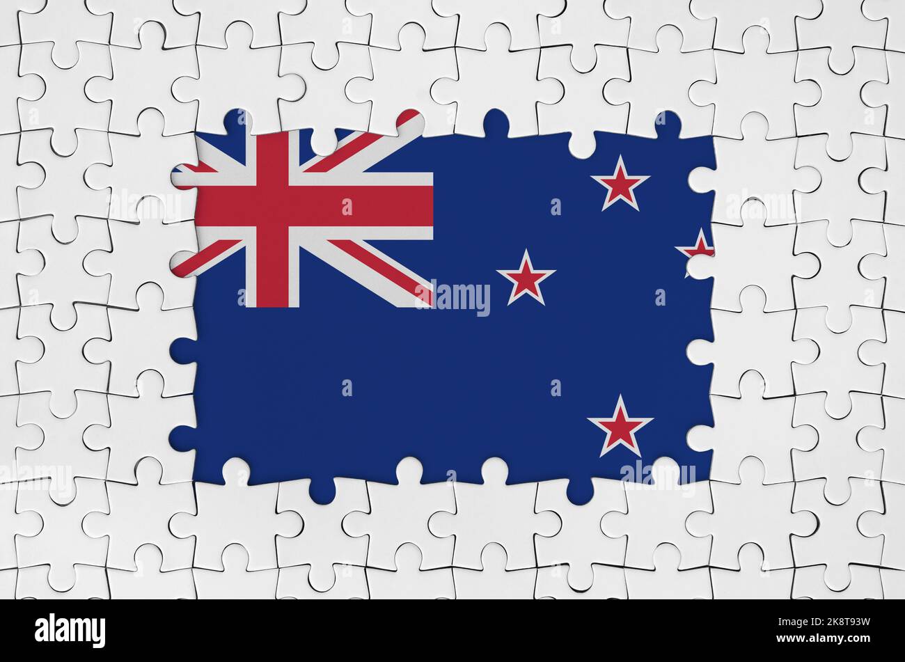 New Zealand flag in frame of white puzzle pieces with missing central ...