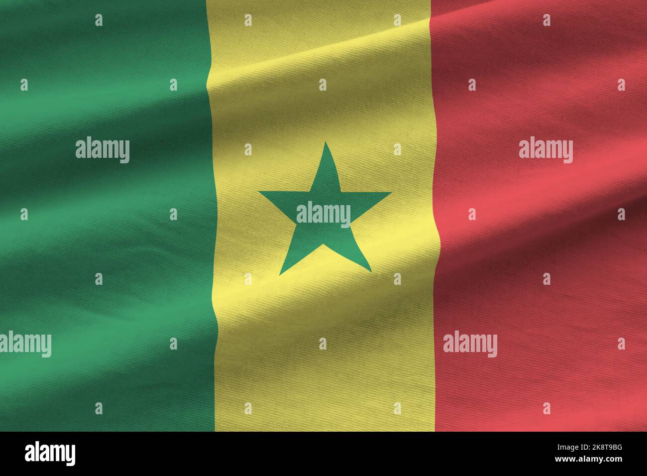 Senegal flag with big folds waving close up under the studio light ...