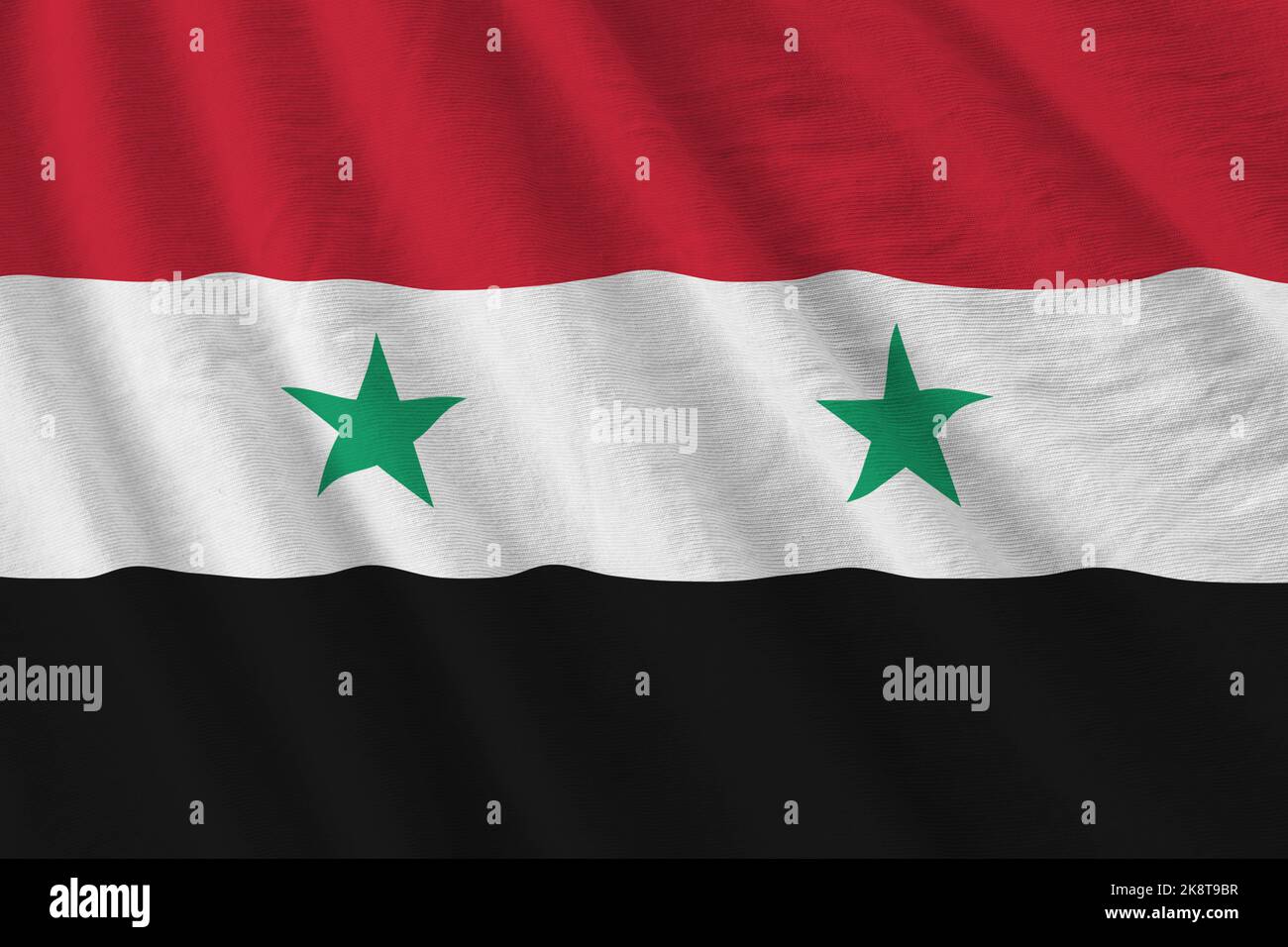 Syria flag with big folds waving close up under the studio light ...