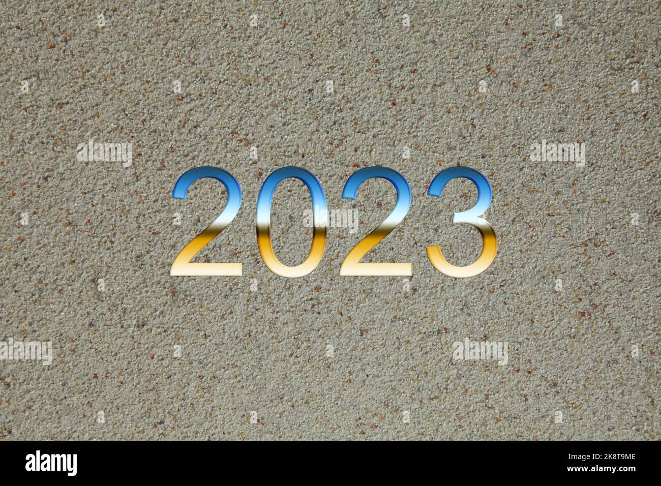Inscription in numbers 2023, is lying on a grey, plastered surface or ...