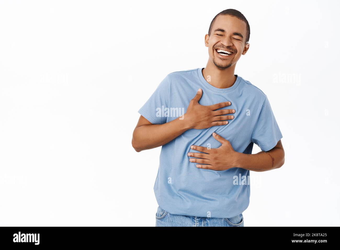 Portrait of arab guy laughing, chuckle over smth funny, standing over ...