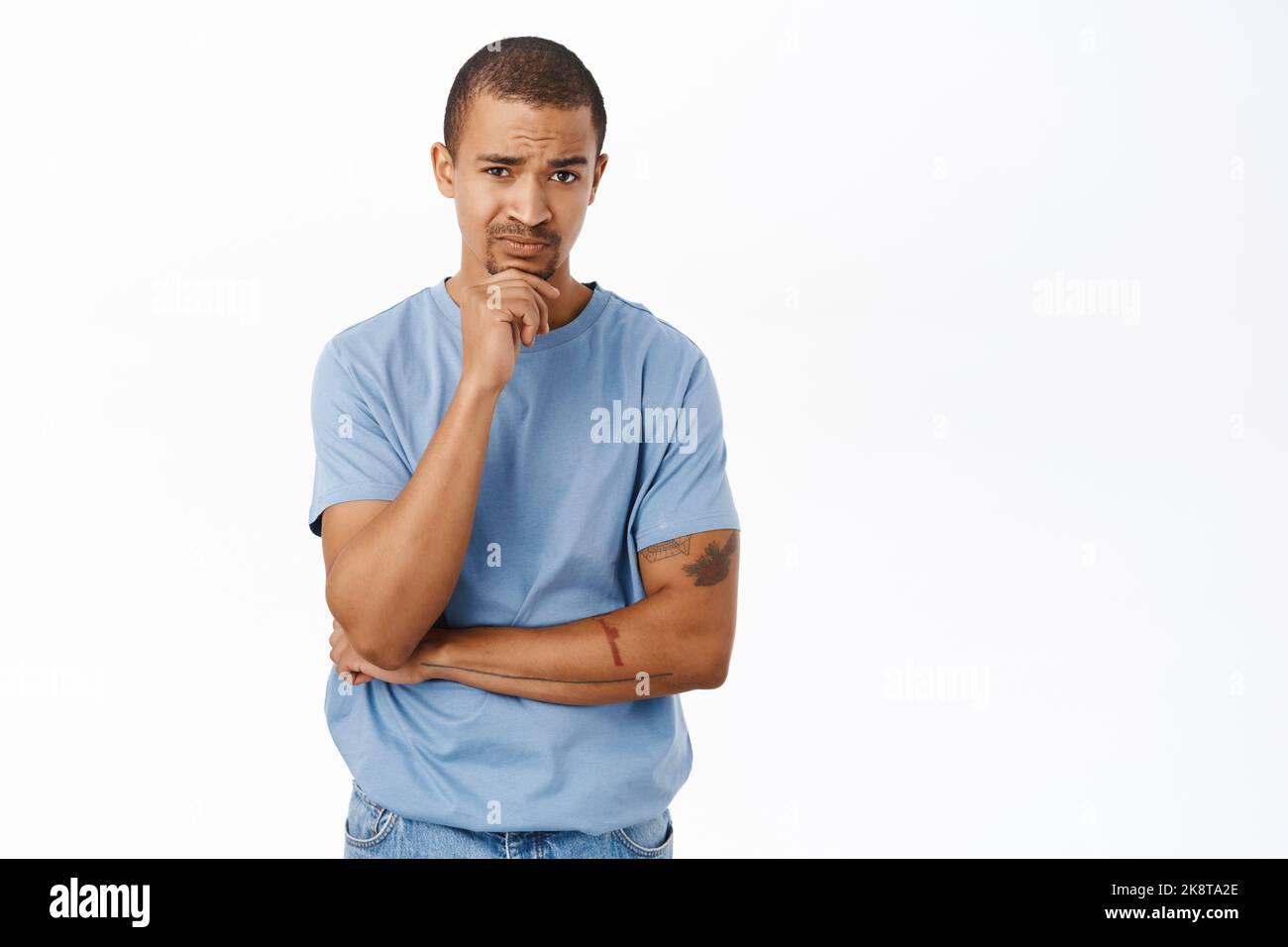 Portrait of man thinking, looking complicated or puzzled while ...