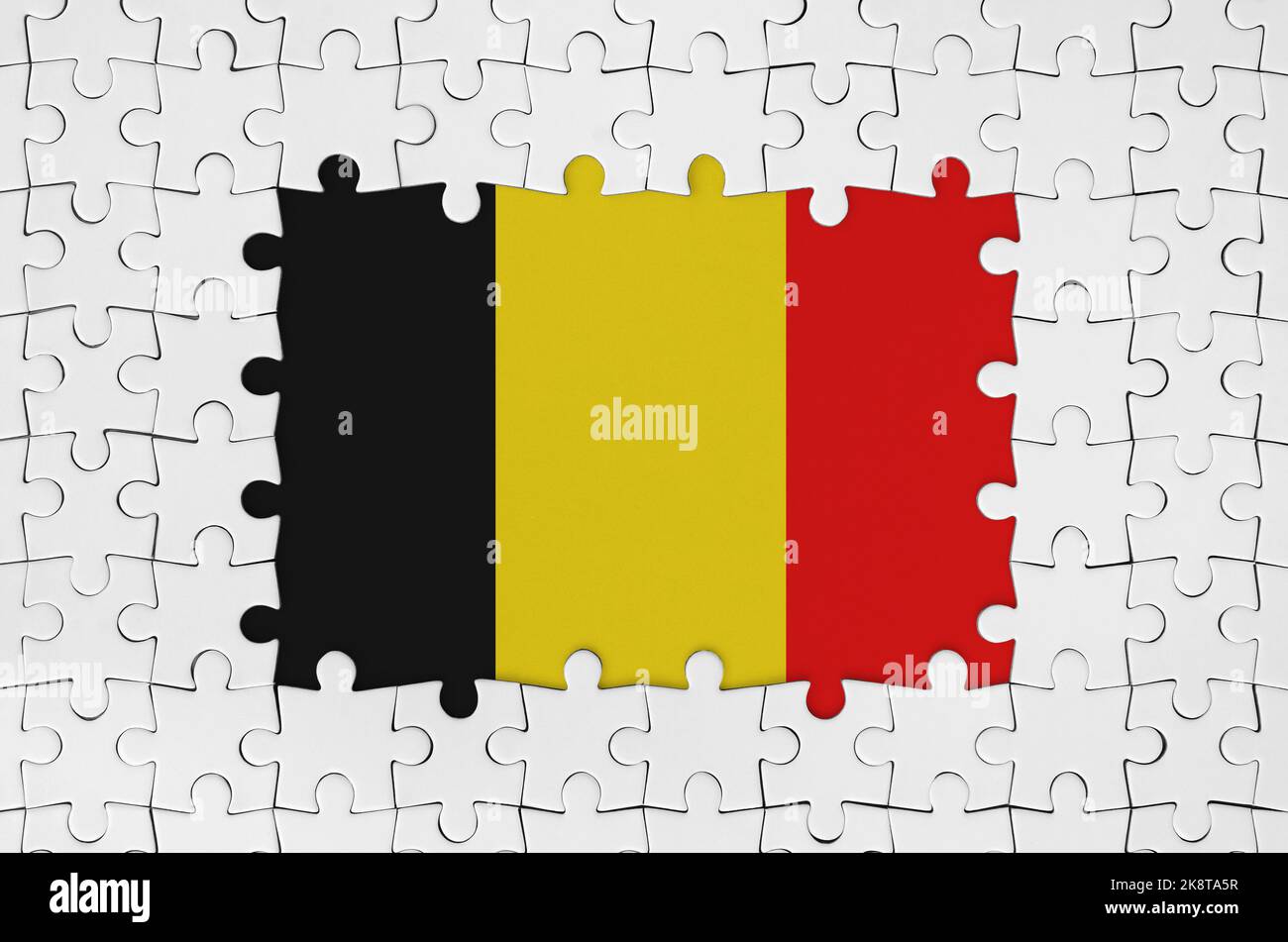 Belgium flag in frame of white puzzle pieces with missing central parts ...