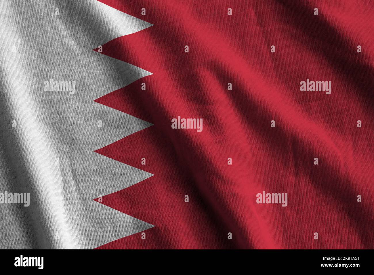 Bahrain flag with big folds waving close up under the studio light ...