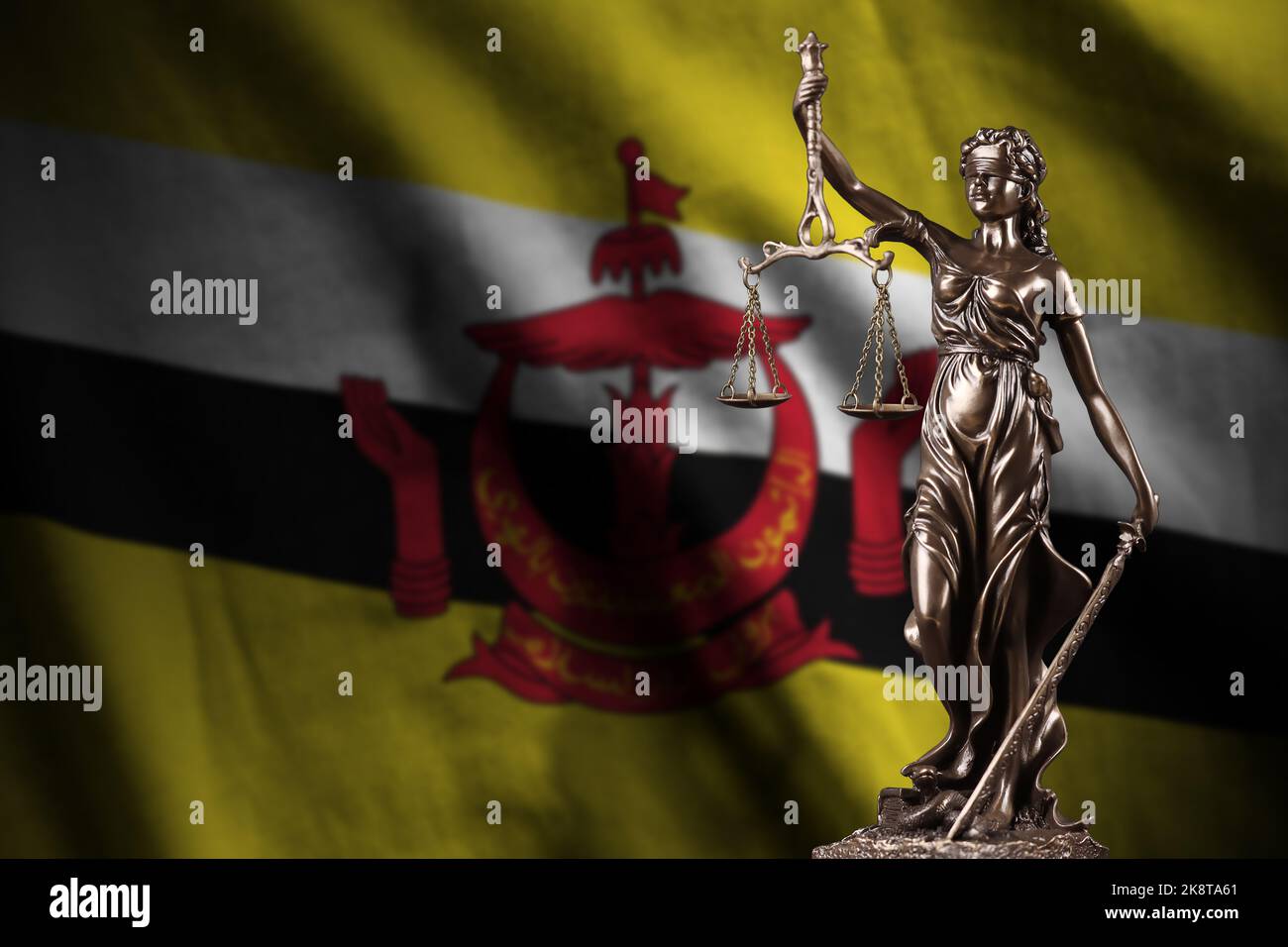 Brunei Darussalam flag with statue of lady justice and judicial scales ...