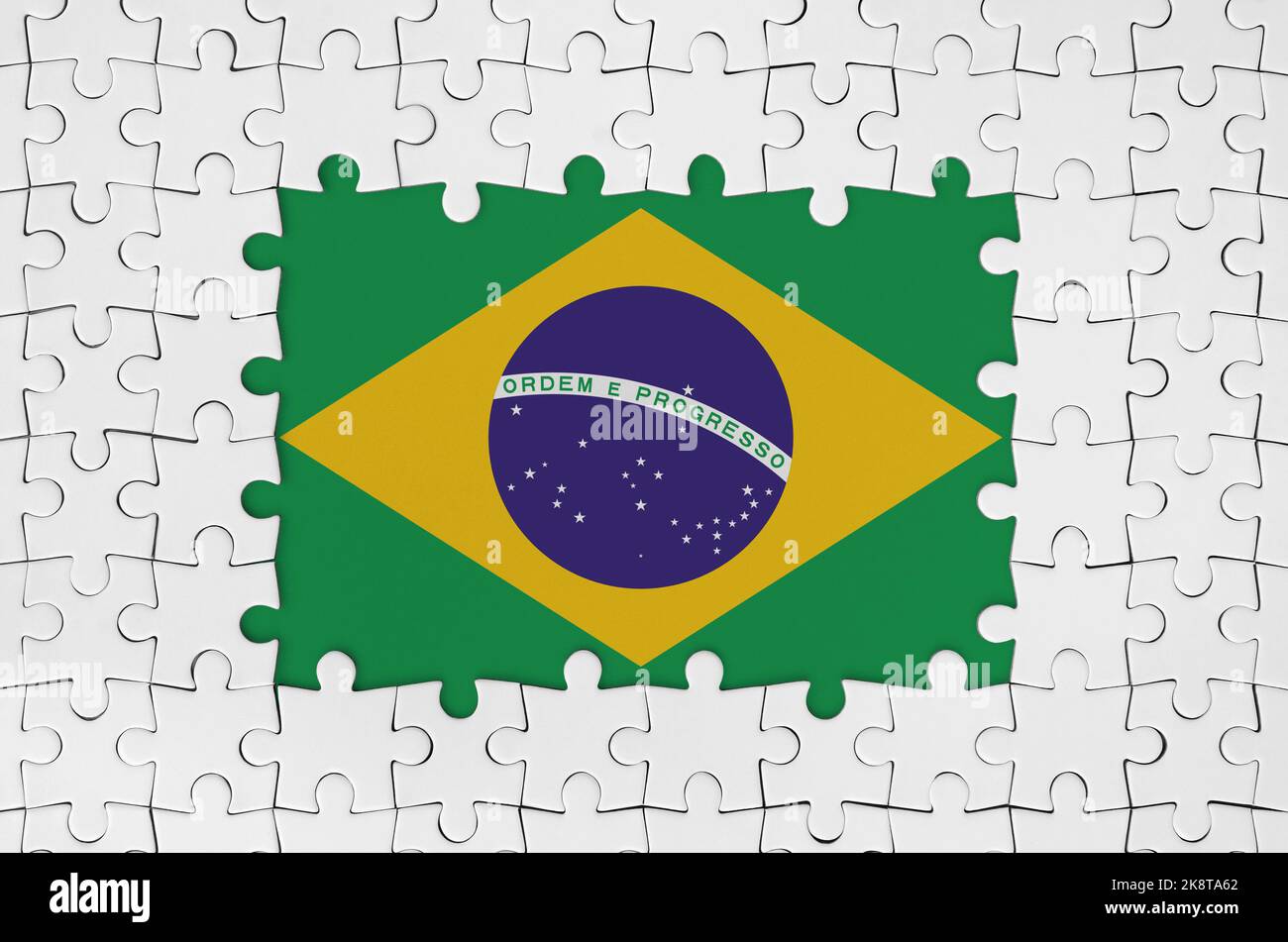 Brazil flag in frame of white puzzle pieces with missing central parts ...