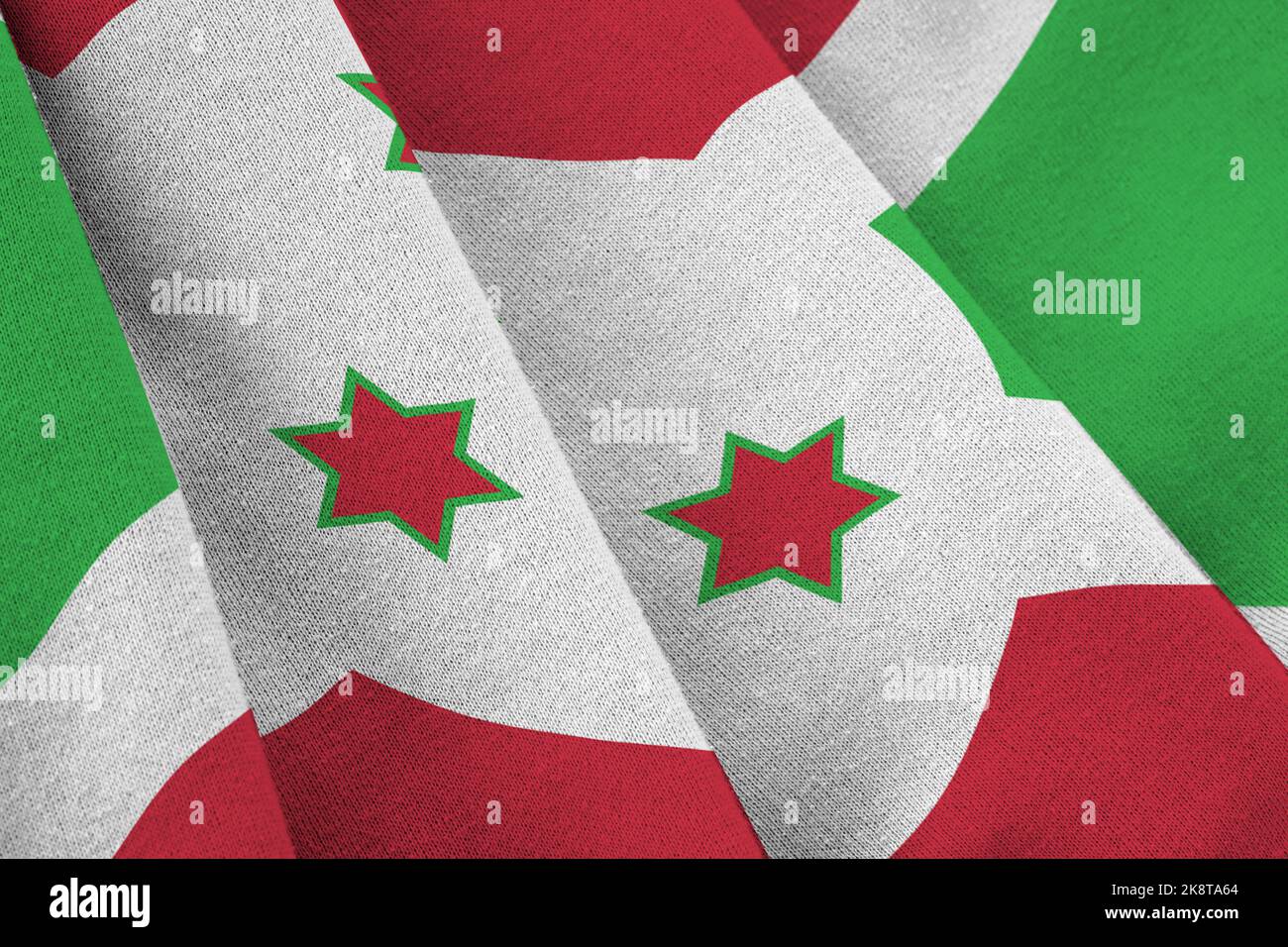 Burundi flag with big folds waving close up under the studio light ...