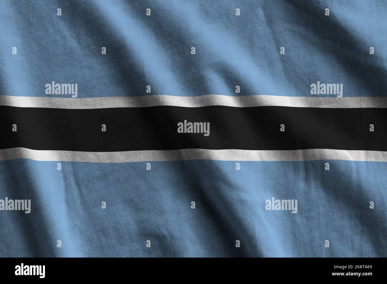Botswana flag with big folds waving close up under the studio light ...