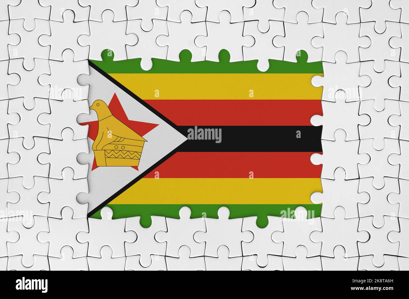 Zimbabwe flag in frame of white puzzle pieces with missing central ...