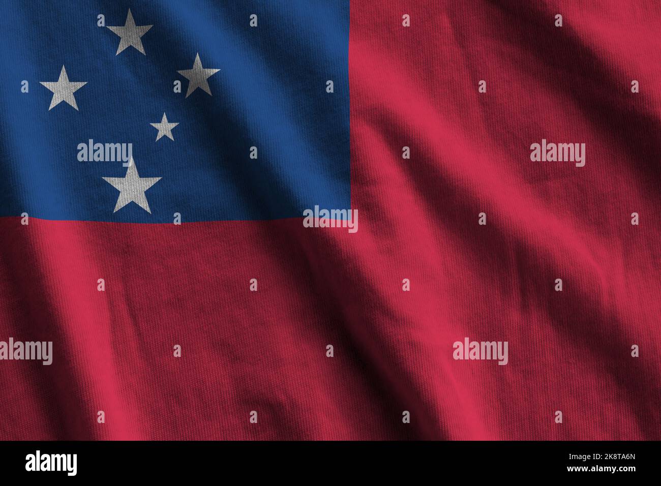 Samoa flag with big folds waving close up under the studio light ...