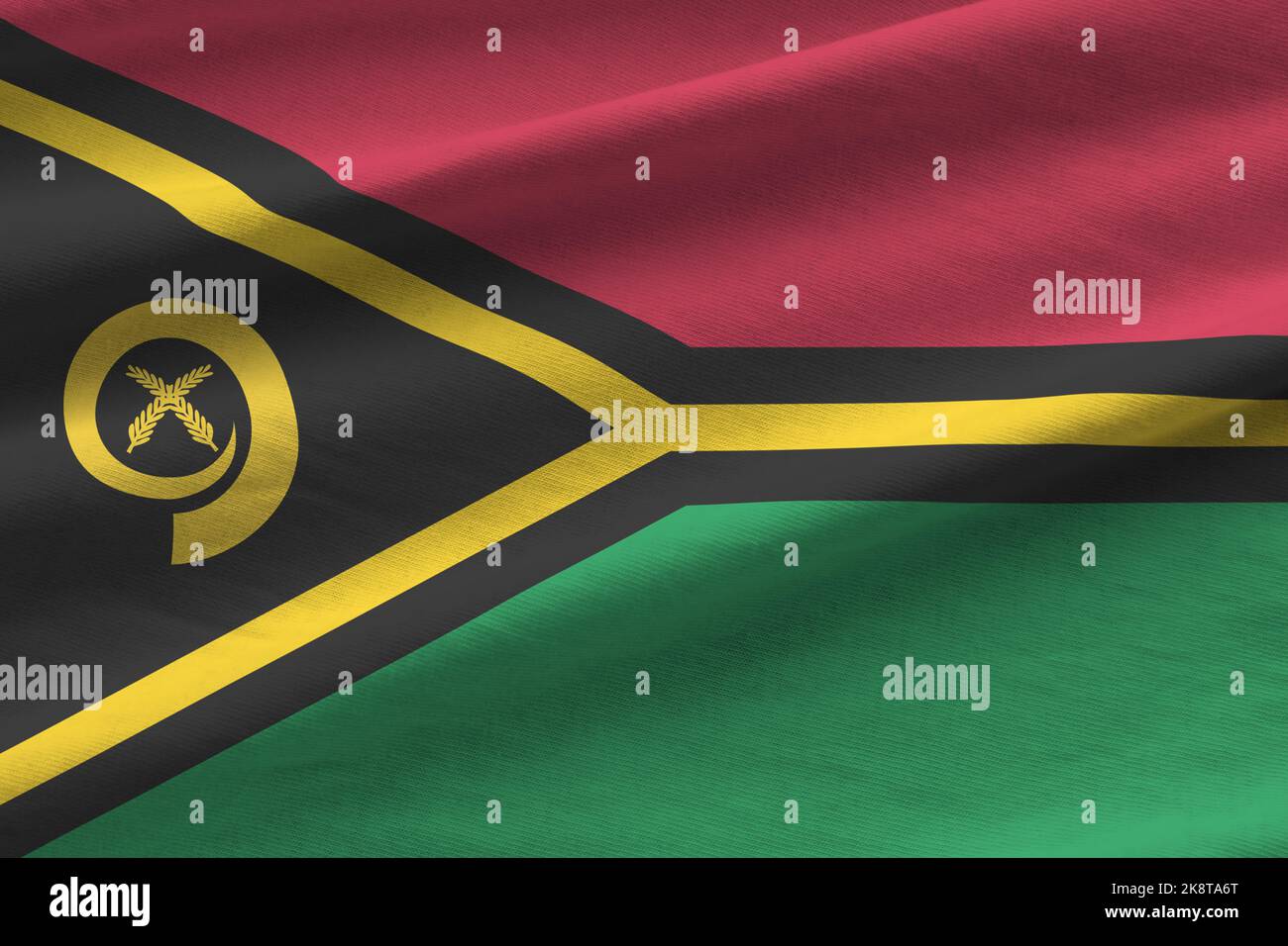 Vanuatu flag with big folds waving close up under the studio light ...