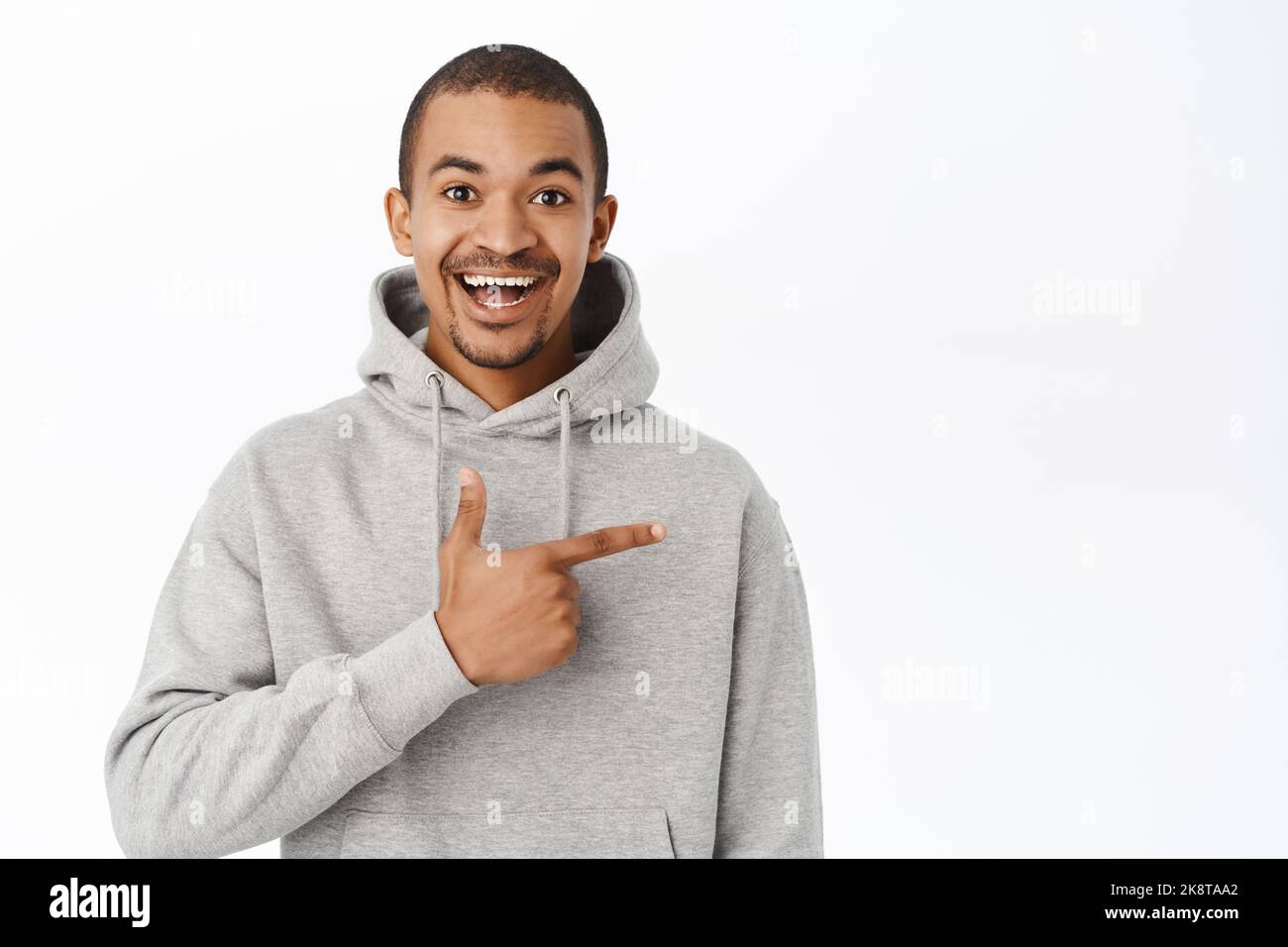 Portrait of handsome smiling man with moustache, wearing grey hoodie ...