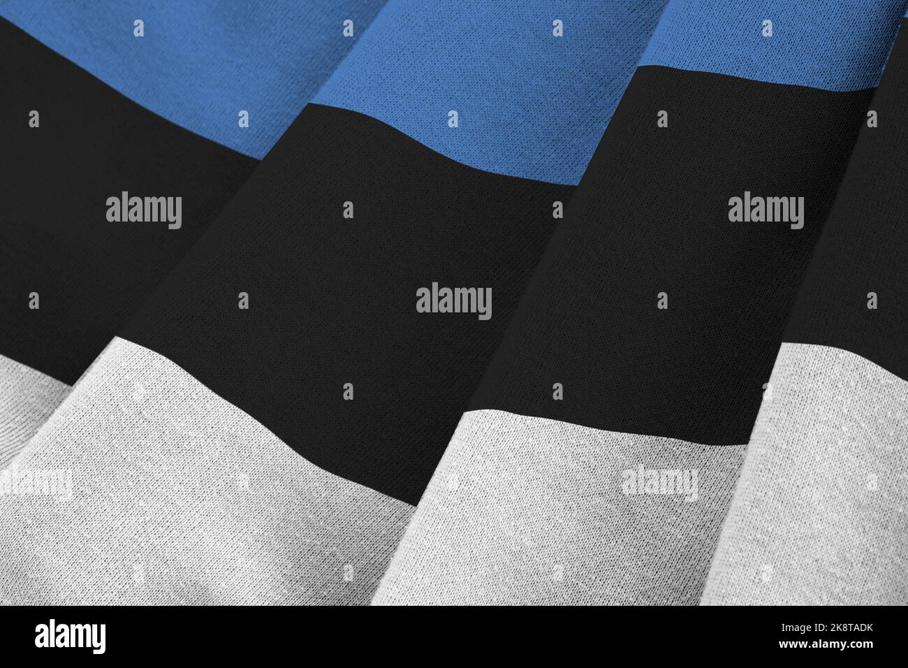 Estonia flag with big folds waving close up under the studio light ...