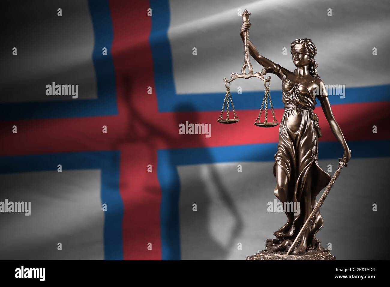 Faroe islands flag with statue of lady justice and judicial scales in ...