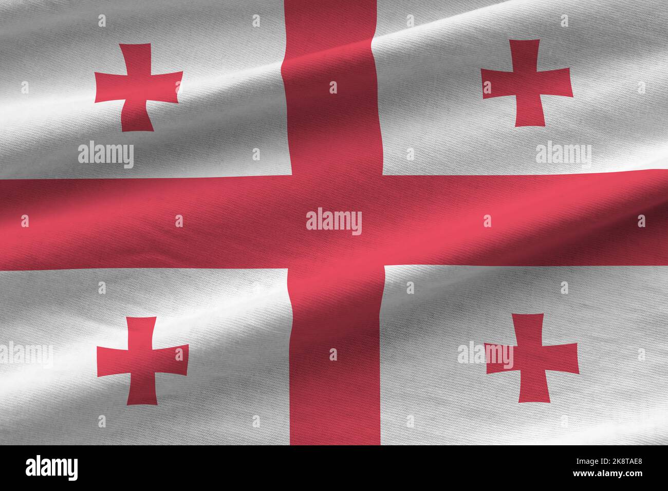 Georgia flag with big folds waving close up under the studio light ...